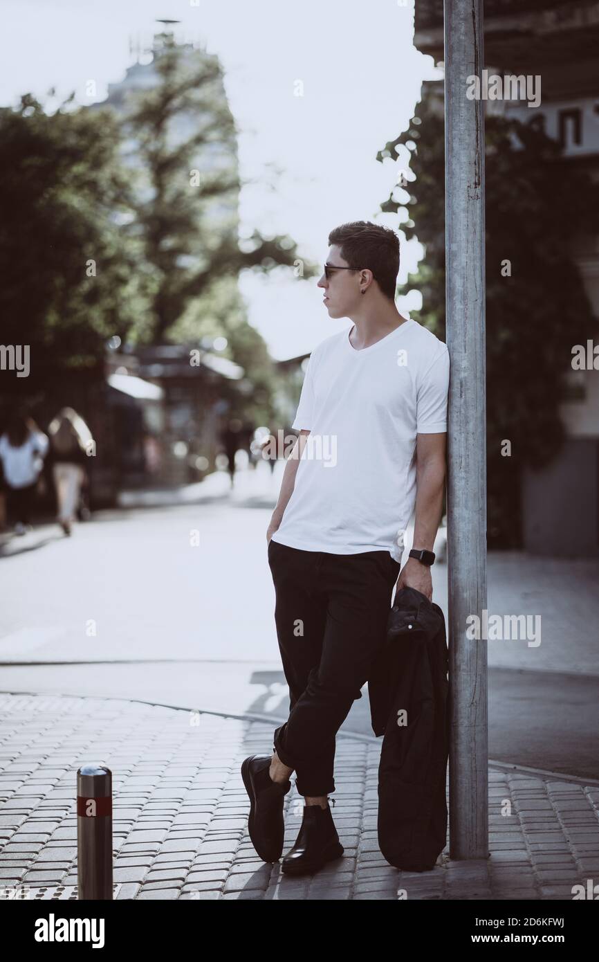 Guy stand on the city street, look camera and around Stock Photo - Alamy