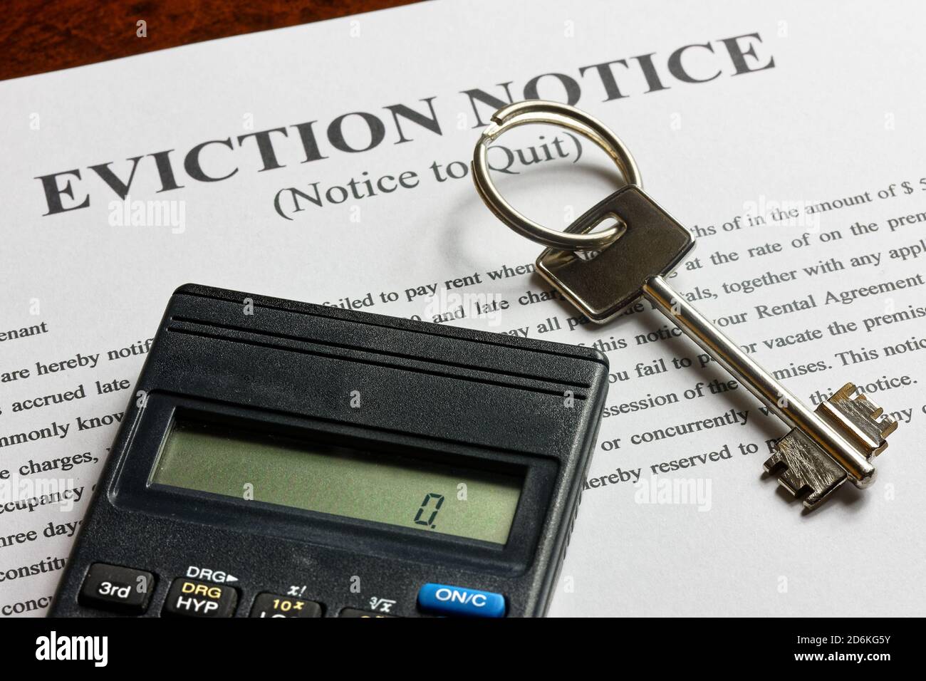 apartment key and calculator on top of the eviction note Stock Photo ...