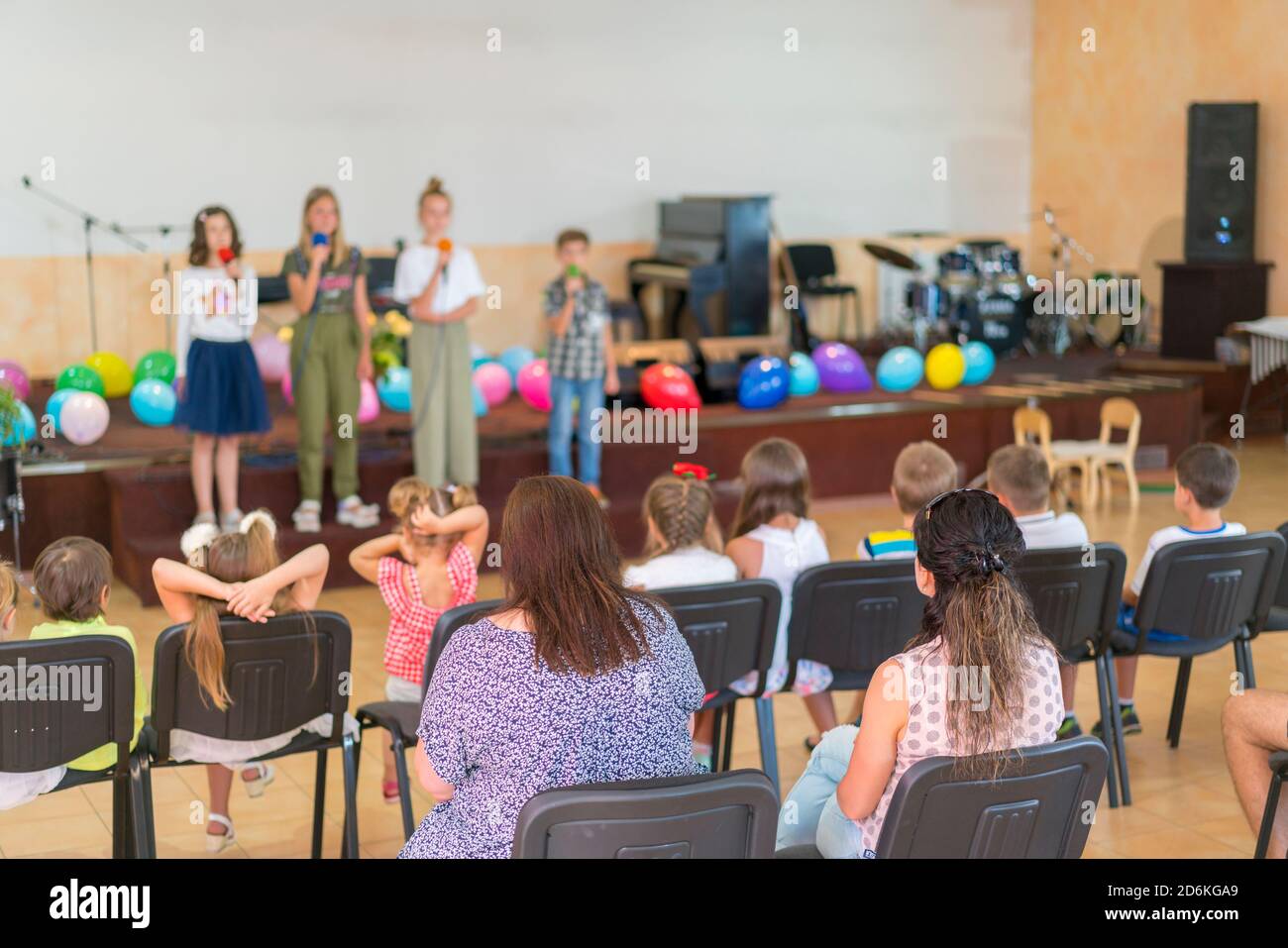 Children's holiday in elementary School. Children on stage perform in ...