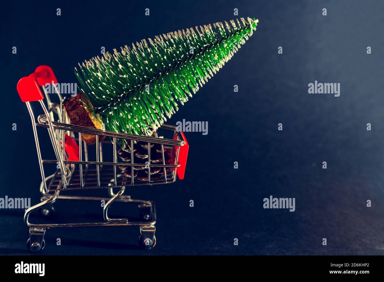 Christmas green tree with fir cone in a trolley Stock Photo - Alamy