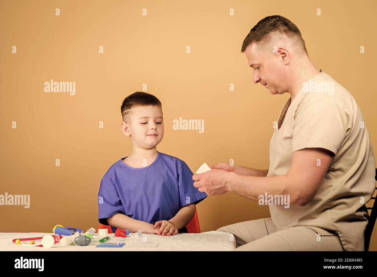 First aid. Medicine concept. Kid little doctor sit table medical tools ...