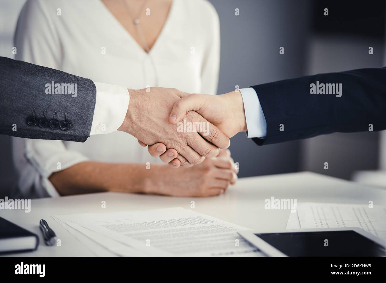 Business people shaking hands finishing contract signing, close-up ...