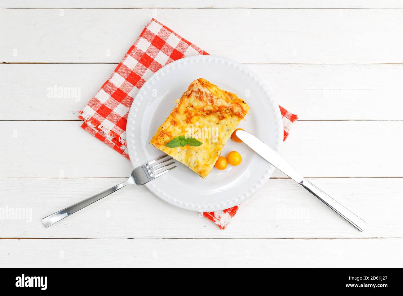Portion of homemade lasagna on white wooden table. Mediterranean ...