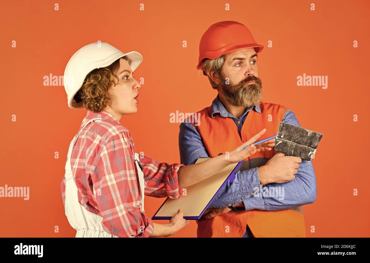 thinking couple. renovation and people concept. Builder Couple Look At ...