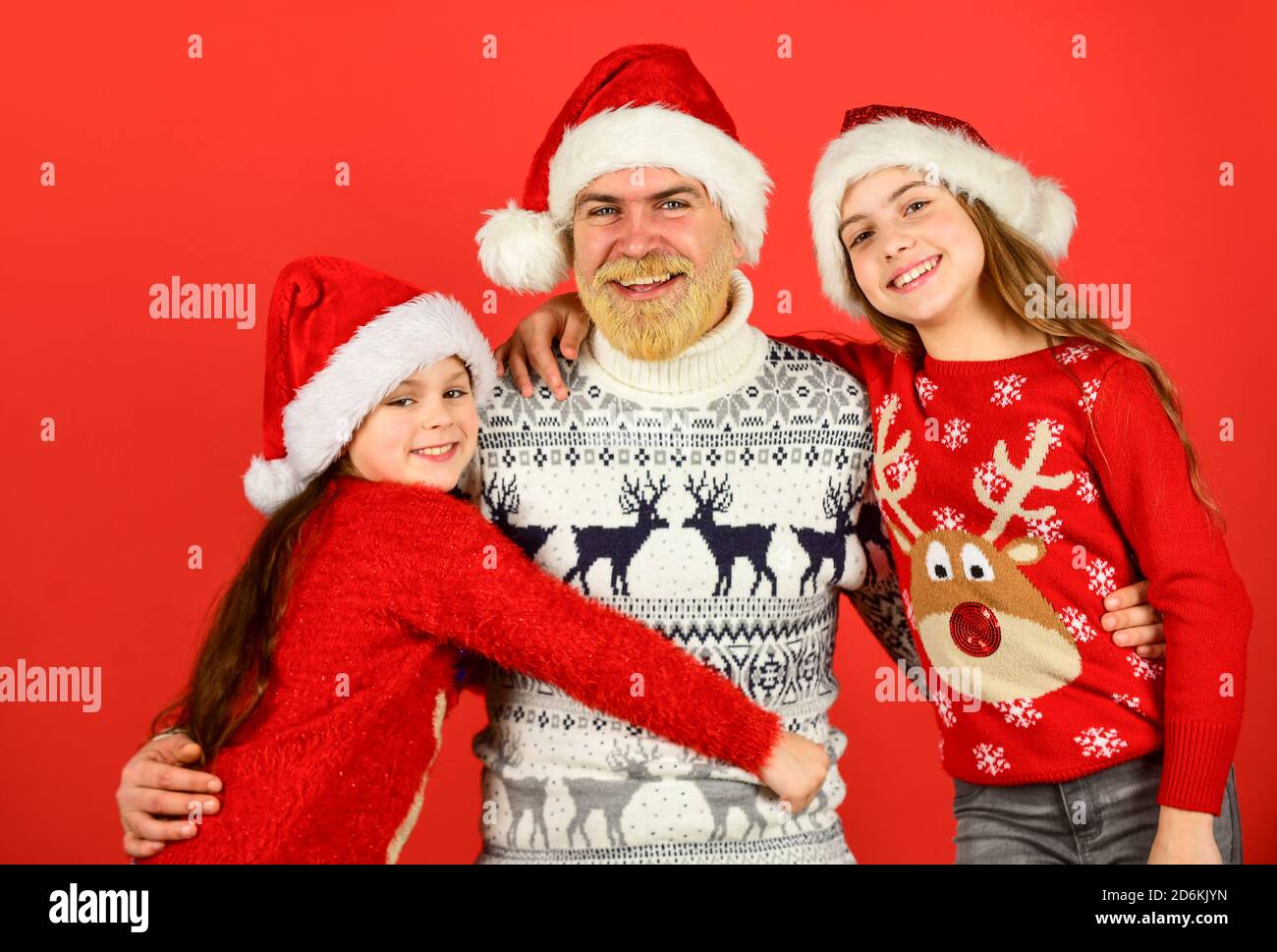 Happy Holidays. small girls love their father. dad embrace daughters ...