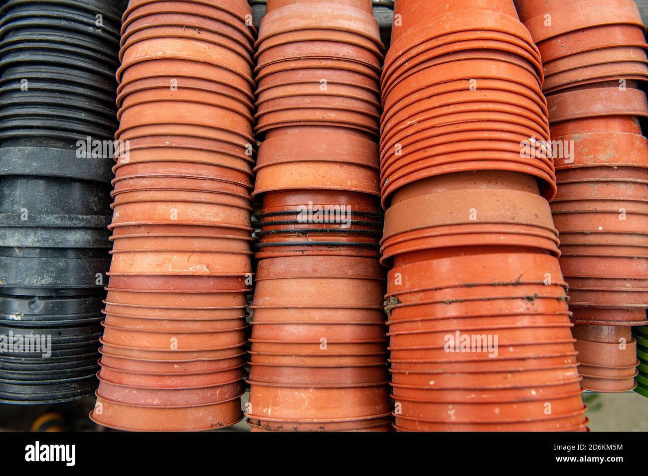 Neatly stacked plstic flower pots in a greenhouse Stock Photo - Alamy