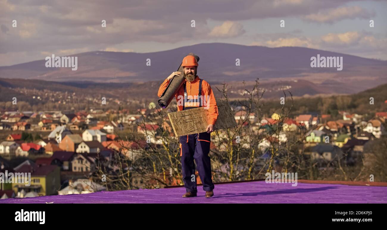 Roofer contractor laying rooftop with protective helmet. man roofer ...