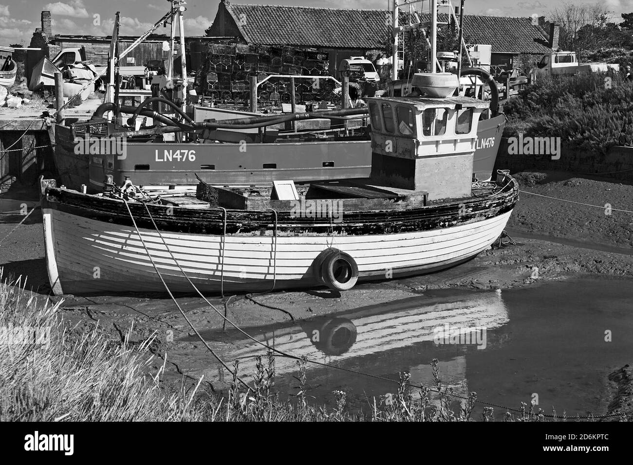 Boats in Brancaster Staithe Harbour at low tide on the Norfolk coast ...