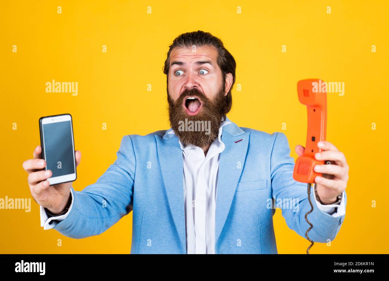 Modern mobile phone and old vintage classic telephone. Technology is ...