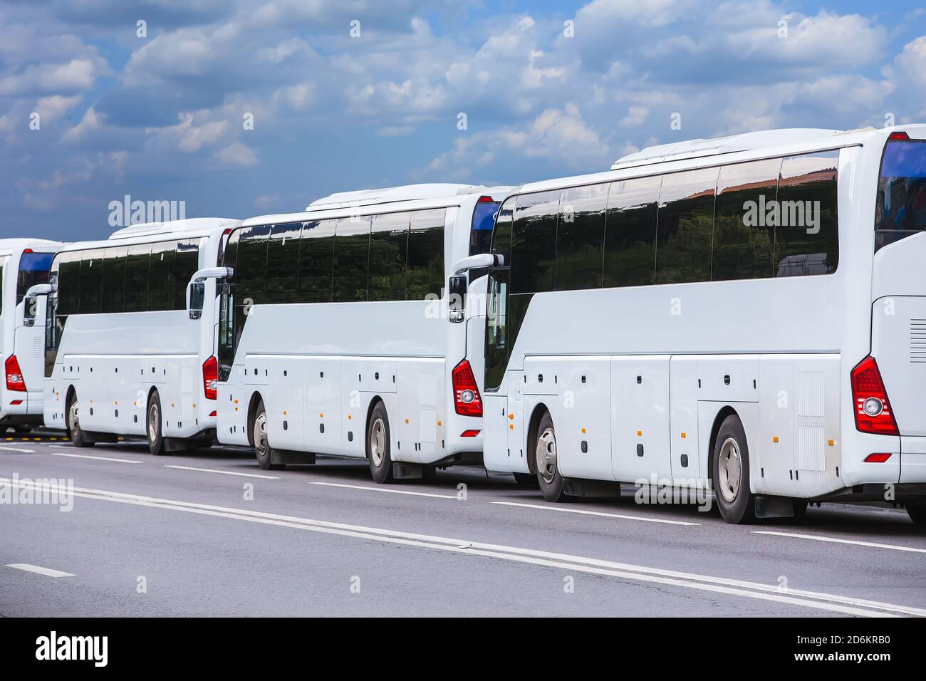 Tourist buses on a city street in summer Stock Photo - Alamy