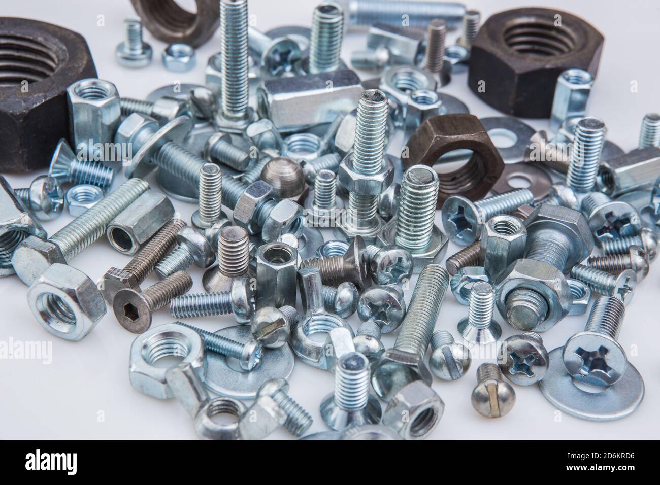 chromeplated bolts and nuts on white background Stock Photo - Alamy
