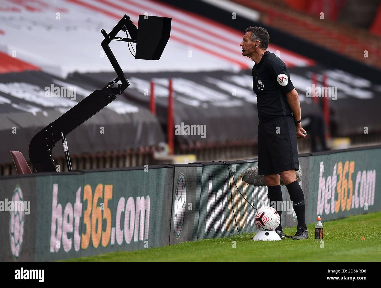 Referee Andre Marriner checks the VAR pitch side monitor during the ...