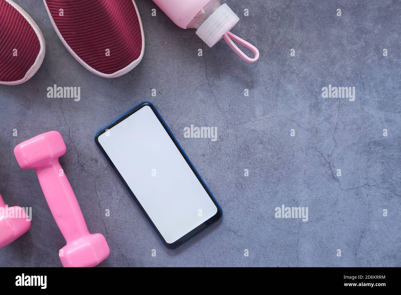 Smart phone with sports equipment on black background Stock Photo - Alamy