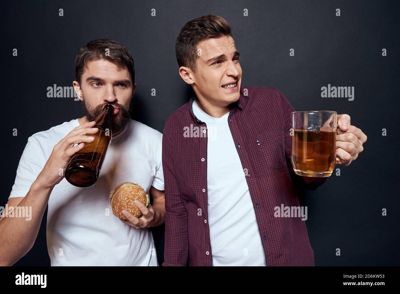 Two drunk friends drinking beer rest fun dark background Stock Photo ...