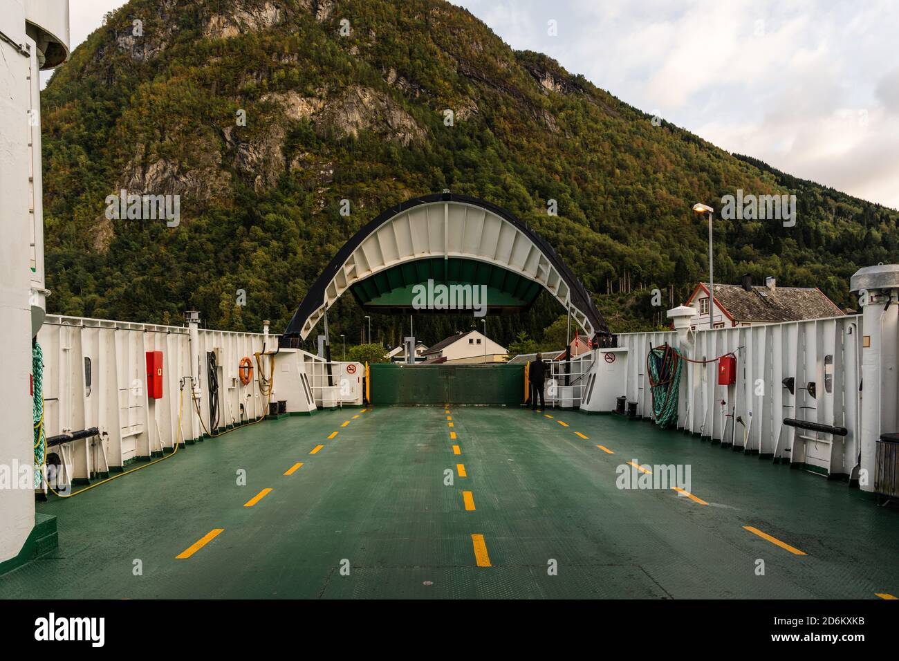 Ferry leaving Eidsdal ferry port whit a man standing and looking on a ...
