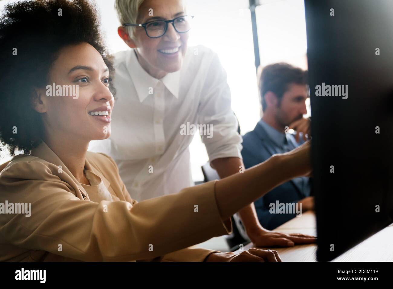 Creative people working in office on computer Stock Photo - Alamy