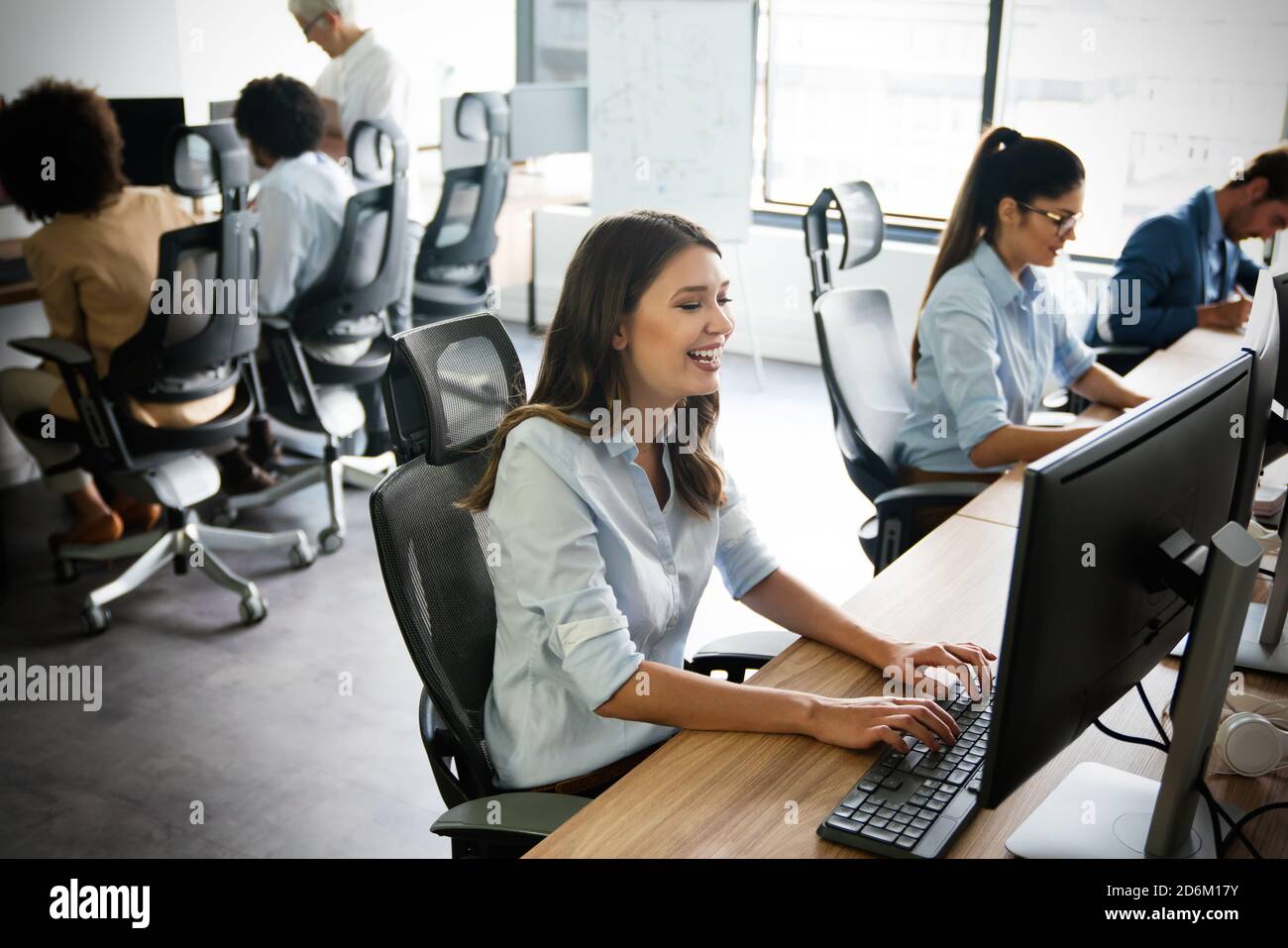 Creative people working in office on computer Stock Photo - Alamy