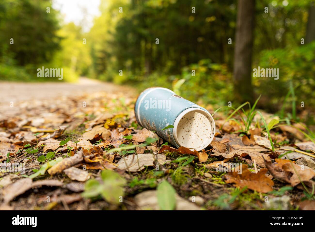 Old disposable coffee cup in the forest. Plastic recycling, pollution ...