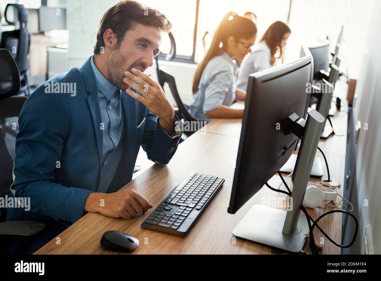 Young exhausted business man with problems and stress in the office ...