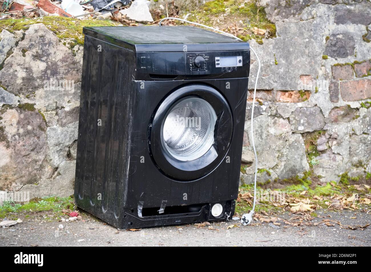 Washing machine left on street by fly tipping gypsy Stock Photo - Alamy
