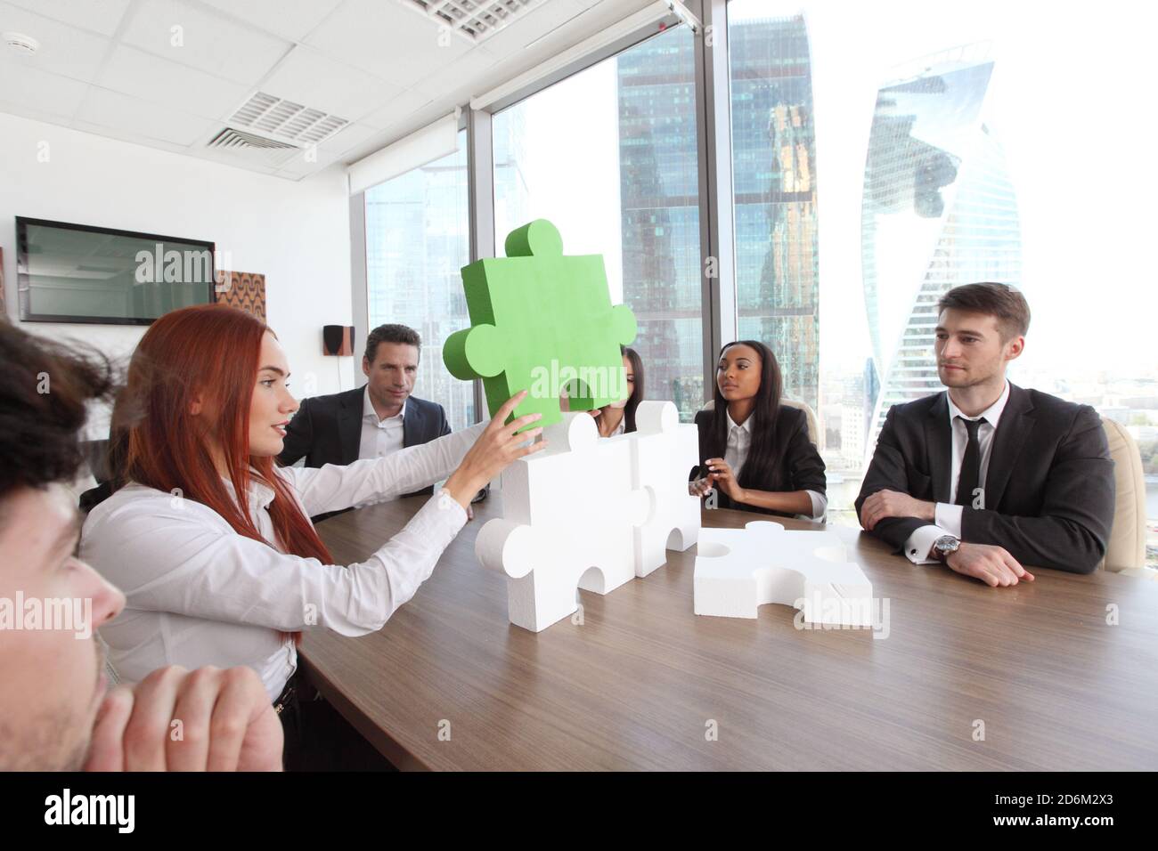 Group of business people assembling jigsaw puzzle and represent team ...