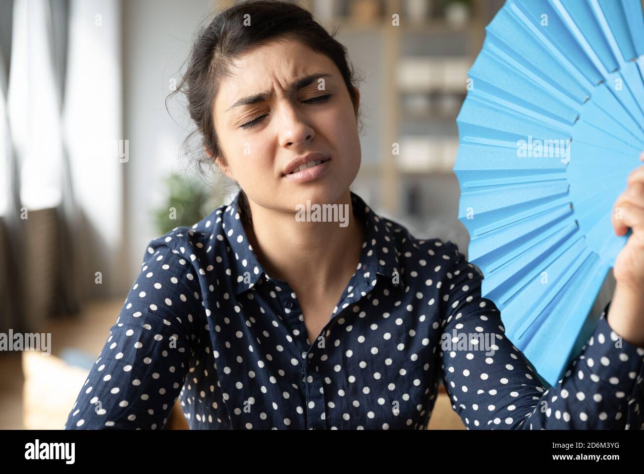 Indian woman suffers from hot weather hold fan cooling herself Stock ...