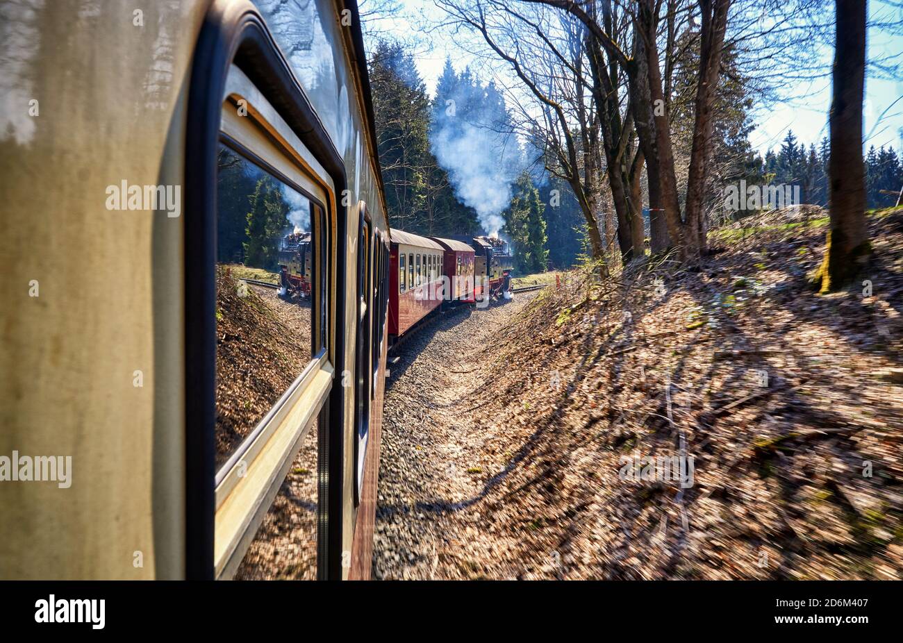 Steam locomotive with railway wagons on the slope in the mountains ...