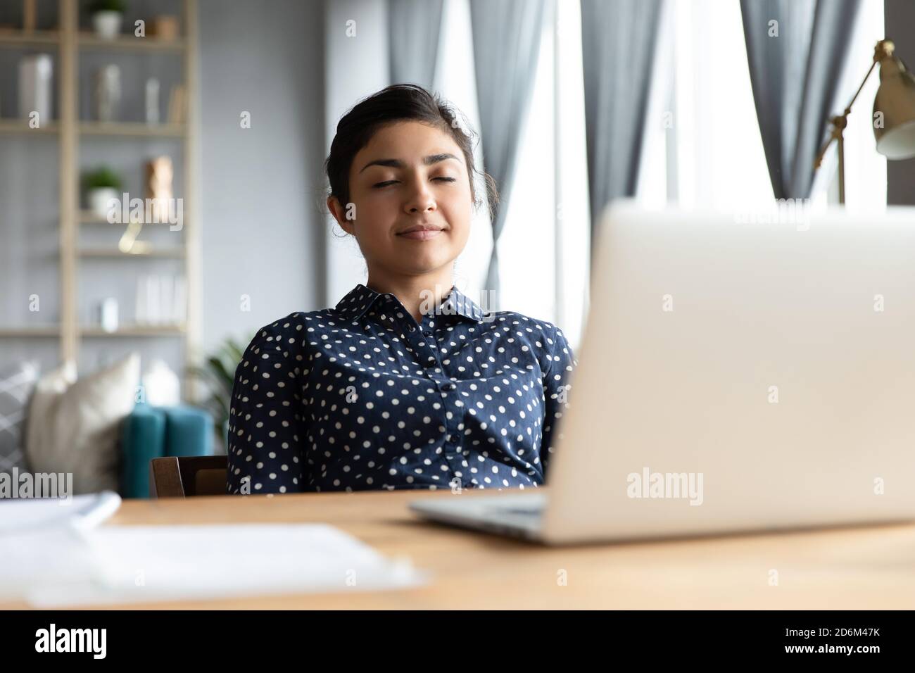 Serene businesswoman lean on office chair relaxing with eyes closed ...