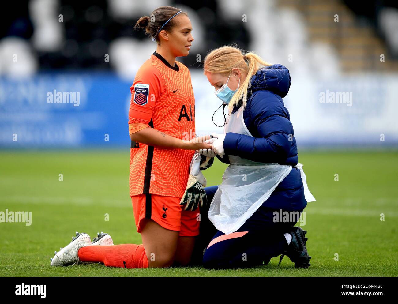 Tottenham Hotspur goalkeeper Rebecca Spencer (left) receives medical ...