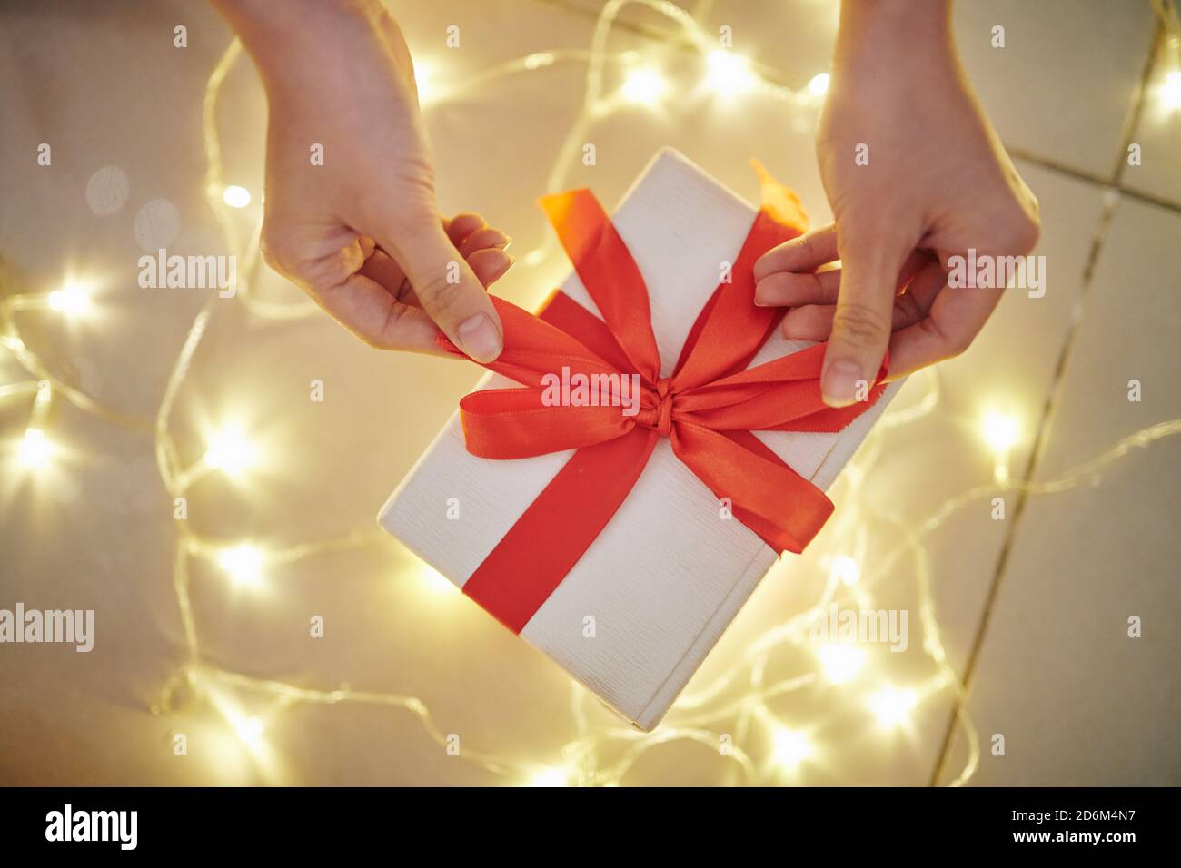 Opening Christmas present Stock Photo - Alamy