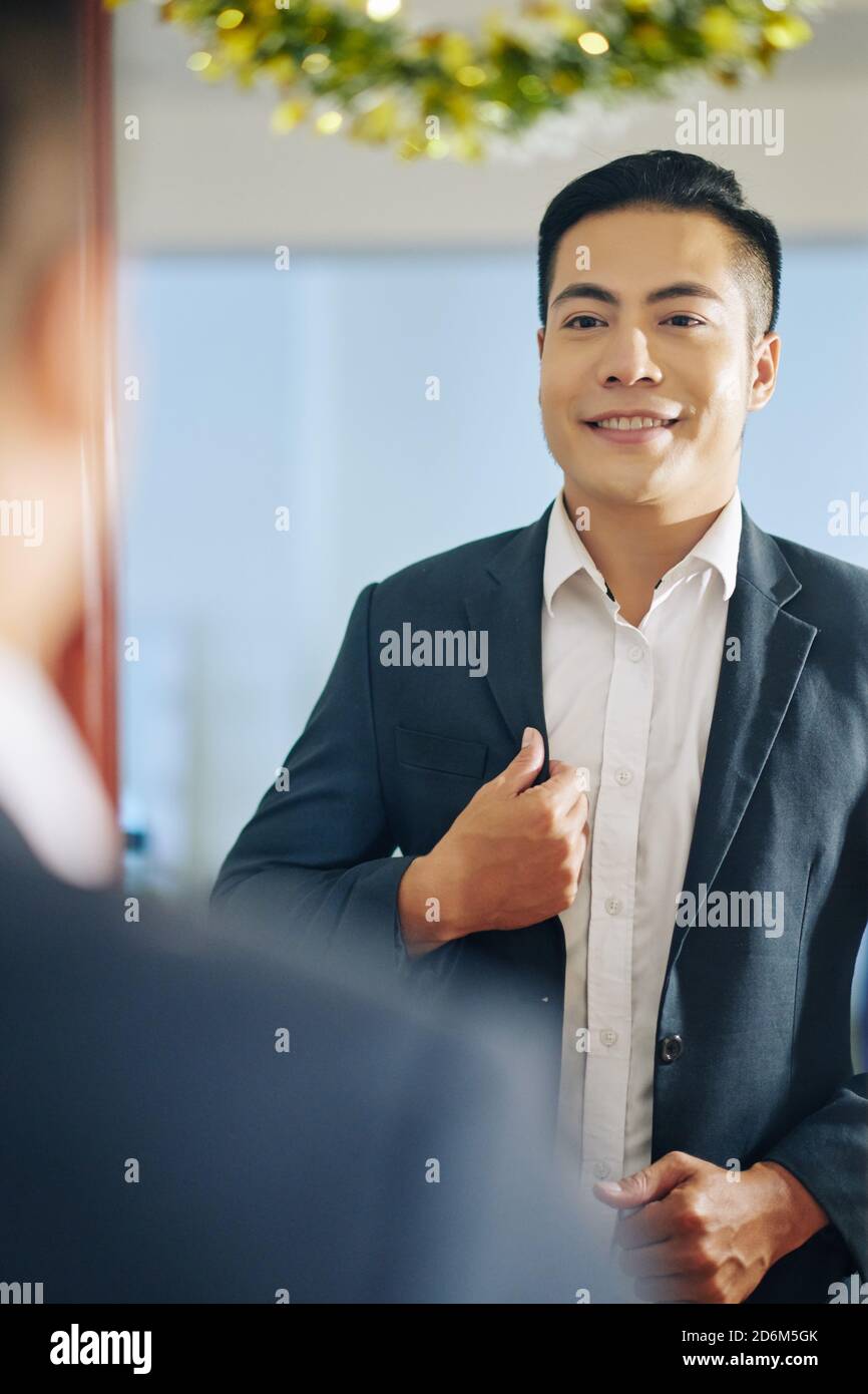 Man putting on jacket Stock Photo - Alamy