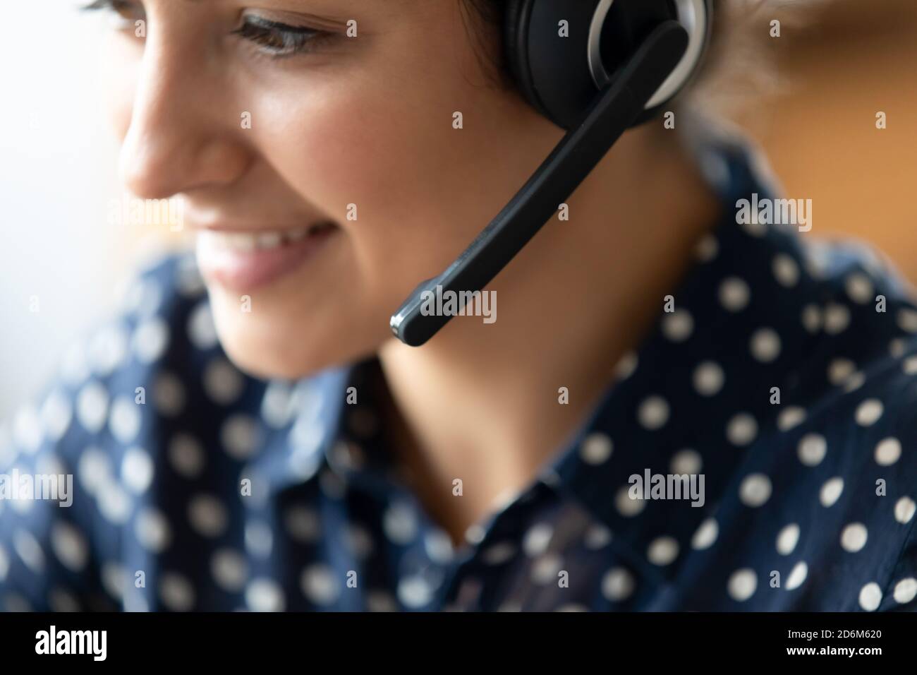 Closeup indian woman helpline employee wear headset talk to client ...