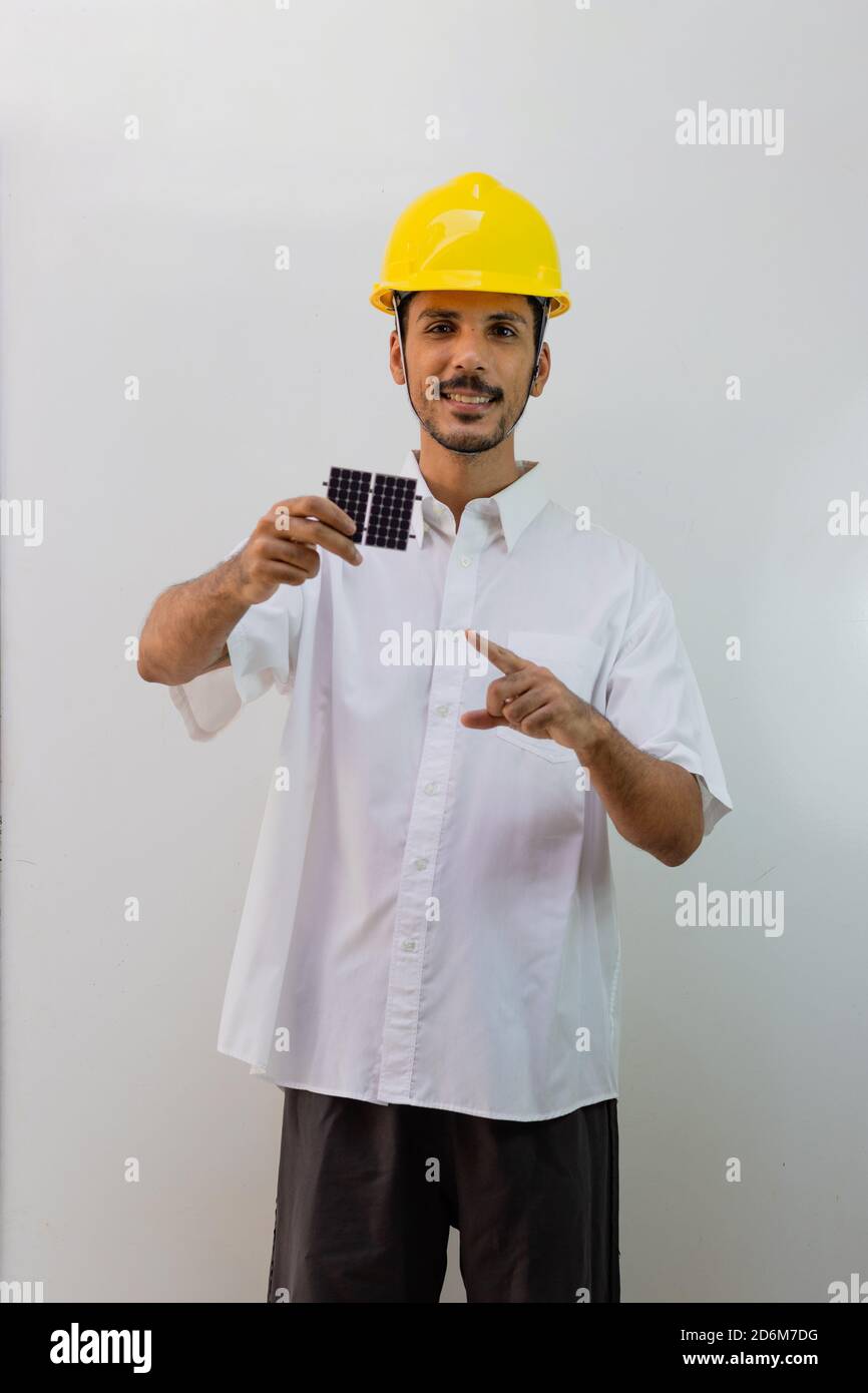 Worker with helmet holding a photovoltaic solar panel isolated on white ...