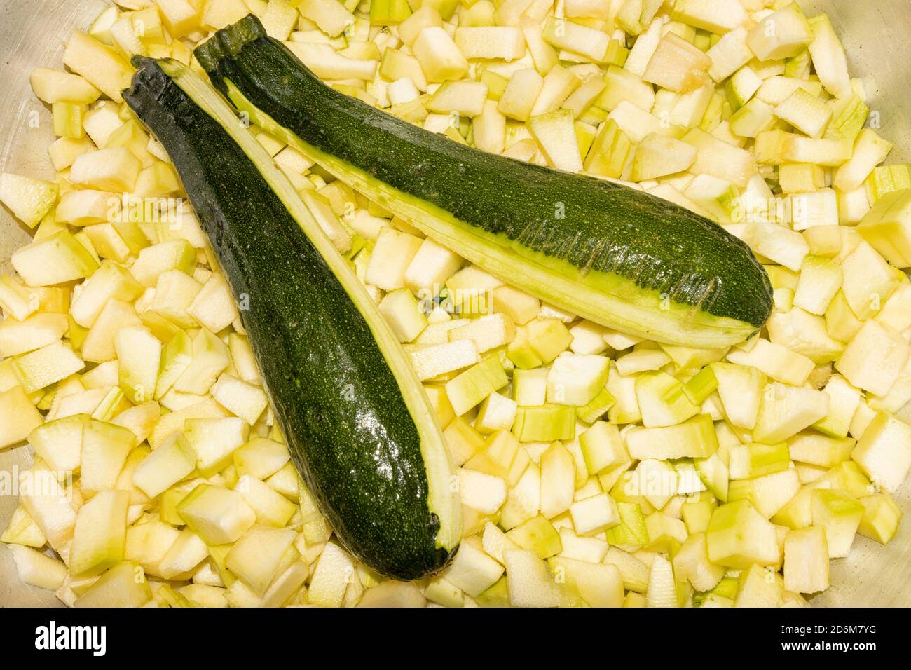 Whole and chopped courgettes - food preparation Stock Photo - Alamy