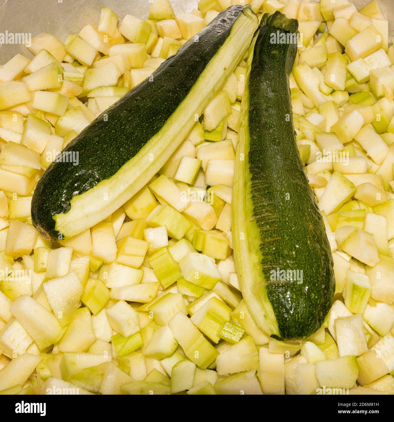 Whole and chopped courgettes - food preparation Stock Photo - Alamy