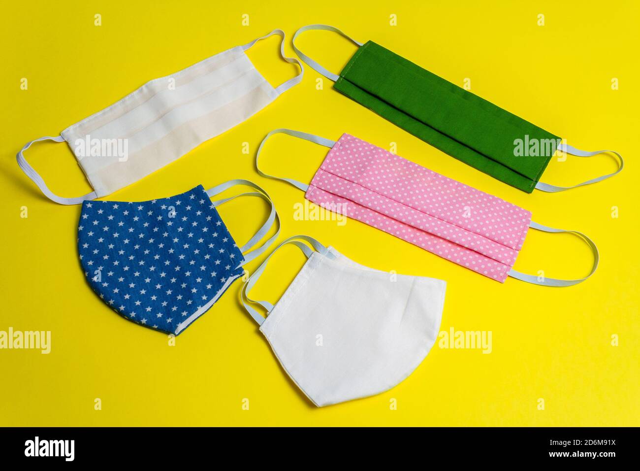 Five colored different reusable medical masks on yellow isolated ...