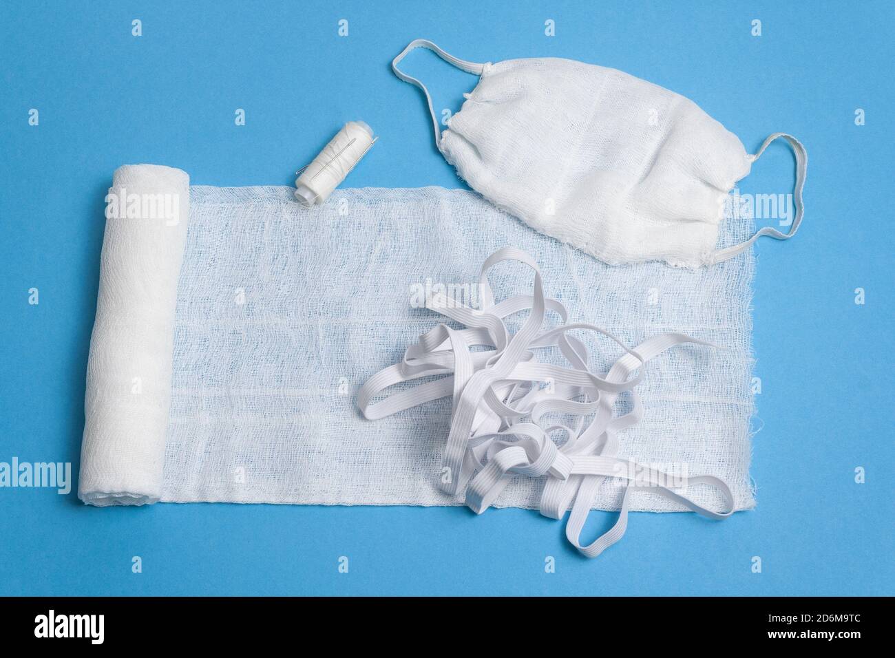 Gauze mask, bandage, threads, needle, rubber on blue background ...