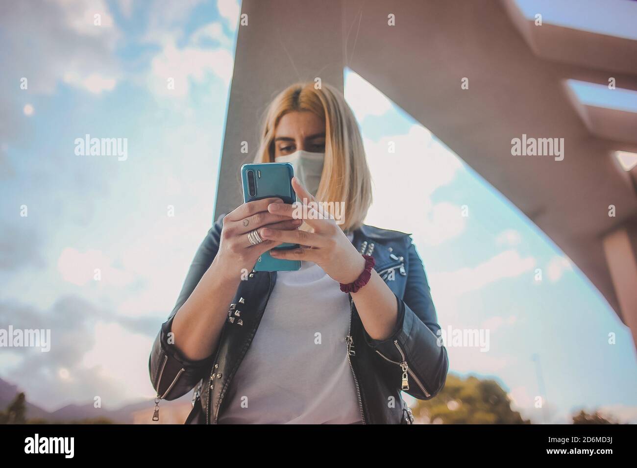 Woman using phone new normal Stock Photo - Alamy