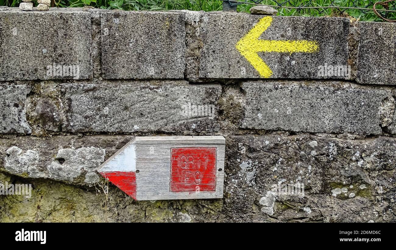 Arrow on a wall indicating to pilgrims the direction to walk in Saint ...