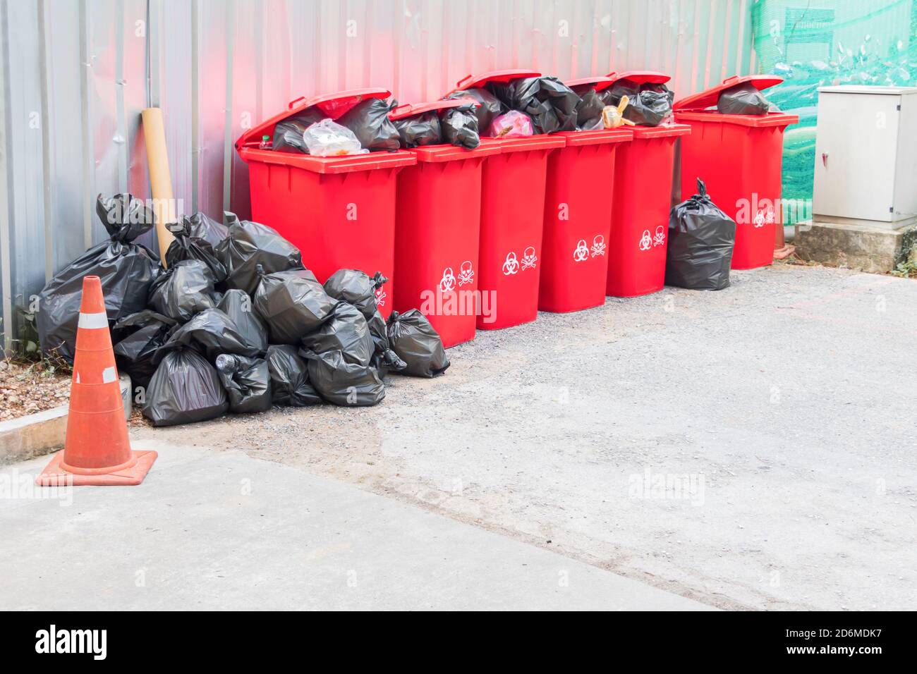 group red bins six with symbol infectious and garbage bag black pile On ...