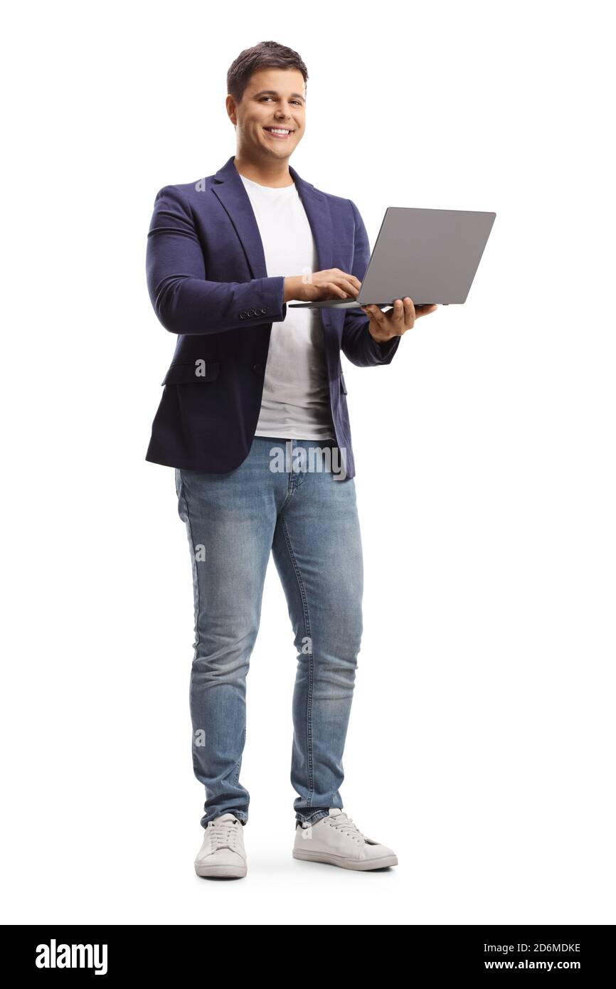 Full length portrait of a young man holding an open laptop computer and ...