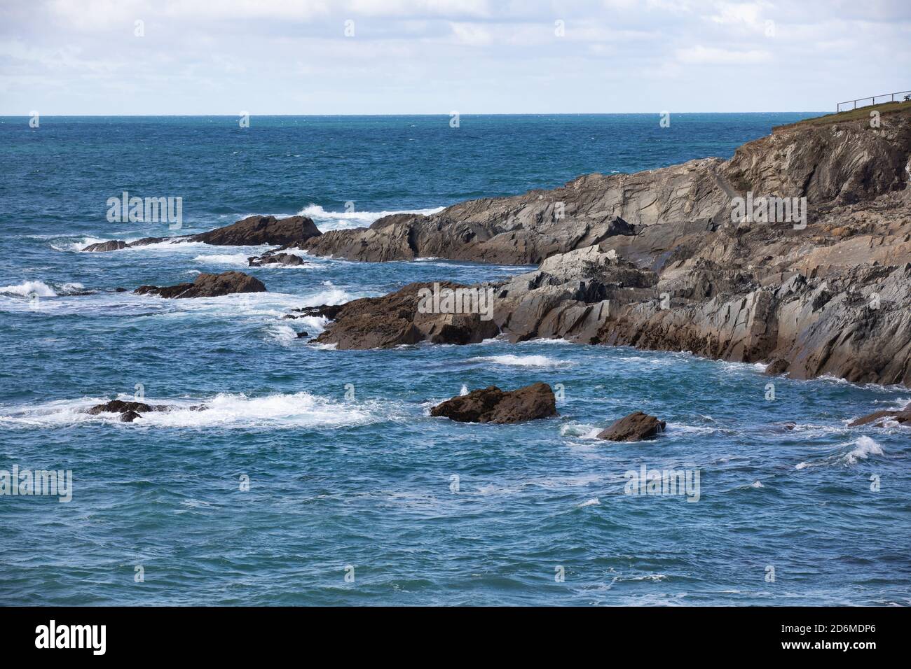 Waves crashing against the rocks in Newquay Cornwall on an autumn day ...