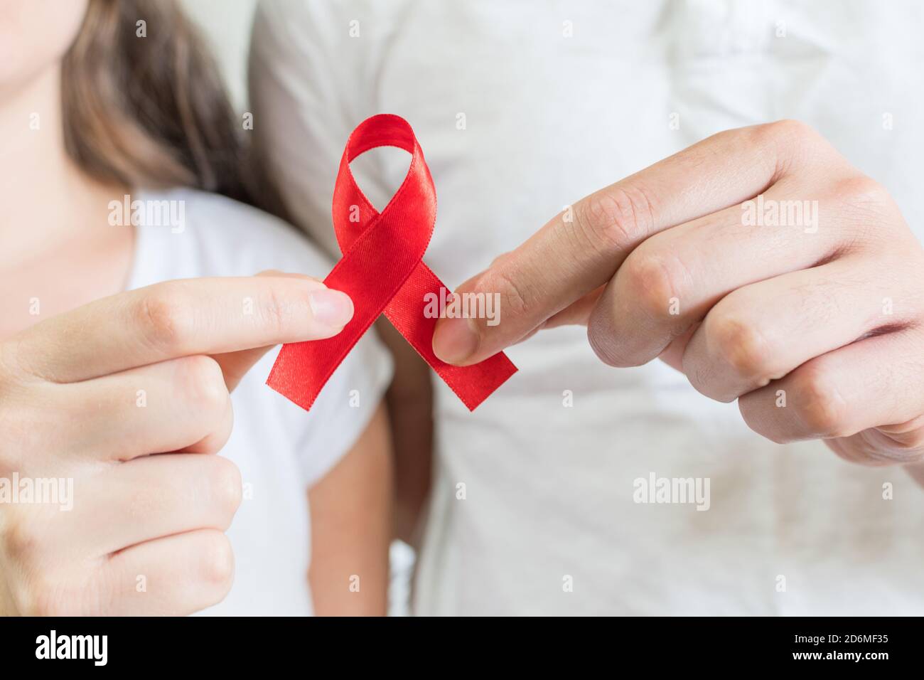 Red ribbon is the universal symbol of awareness and support for people ...