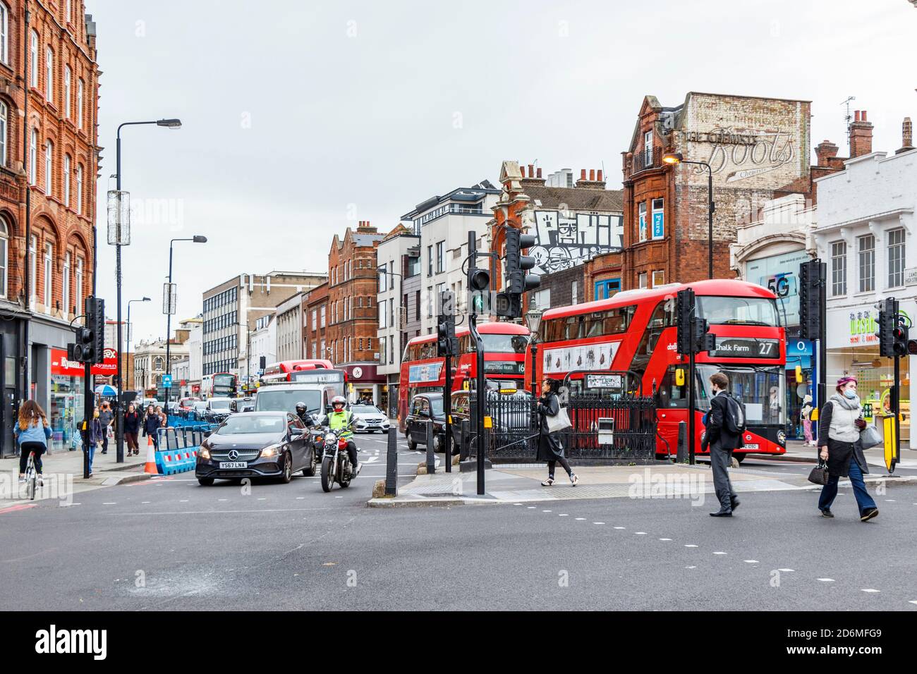 Traffic and pedestrians at an intersection in Camden Town, London, UK ...