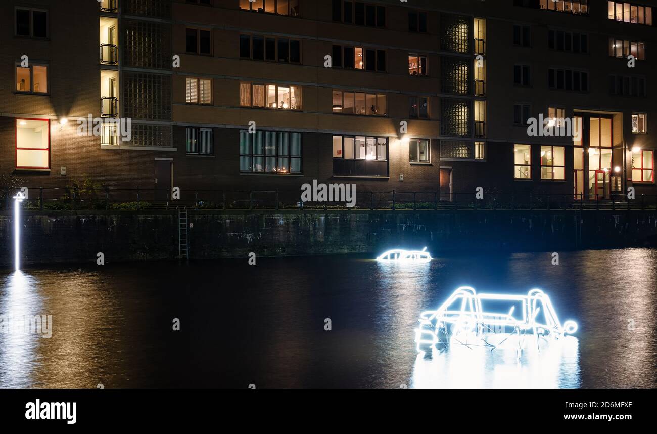 Amsterdam, Netherlands, January 6, 2020: Sinking illuminated cars in a ...