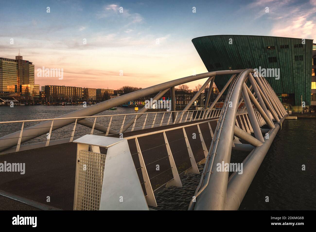 Modern bridge over the Oosterdok canal leading to Nemo Science Museum ...