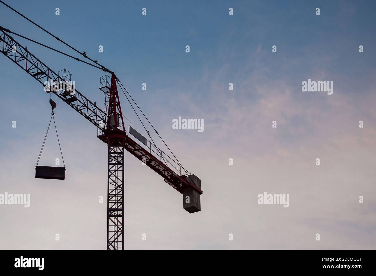 high-rise building crane on the background of the evening sky, building ...