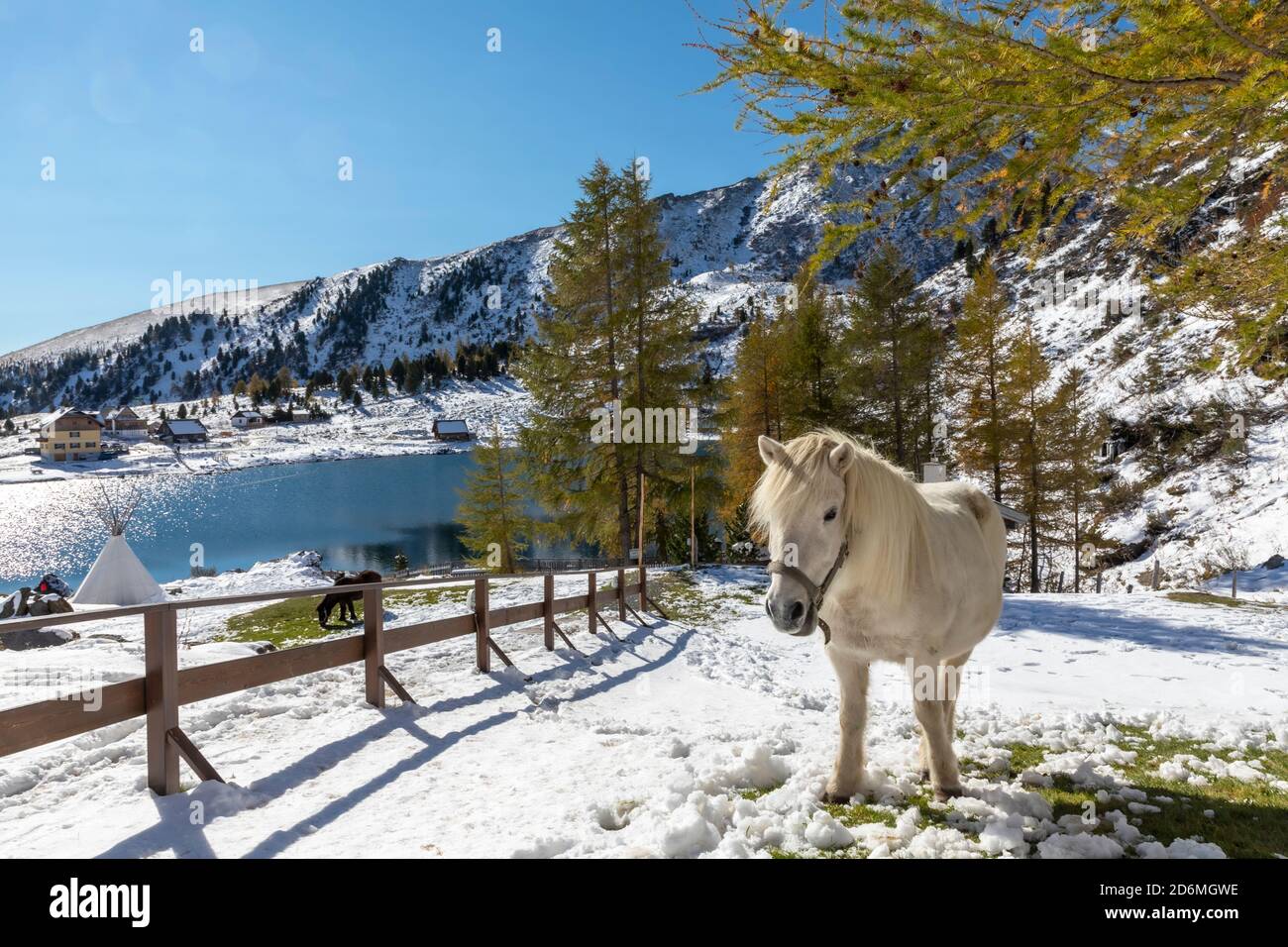 first snow in autumn on mountain lake named Falkertsee in Carinthia ...