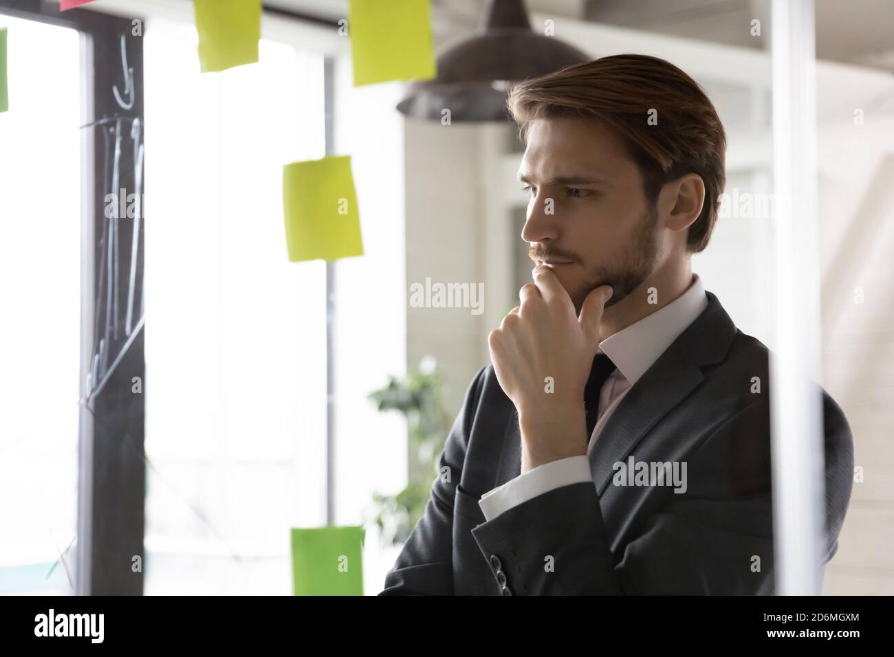 Thoughtful young manager analyzing project to do list Stock Photo - Alamy
