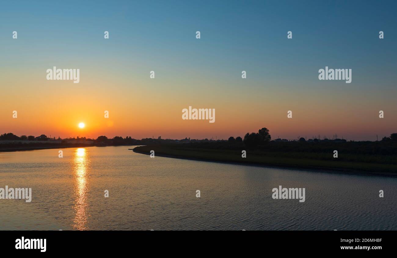 The Kura river flowing through the city of Neftechala at sunset Stock ...